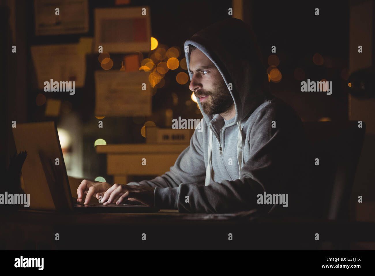 Man using a laptop at night Stock Photo - Alamy