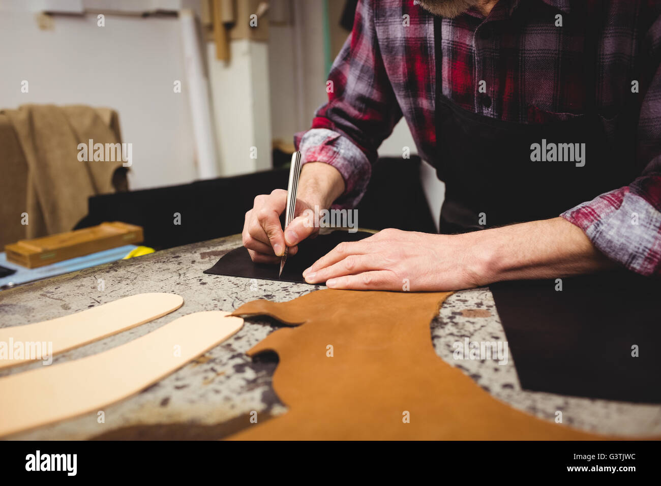 Close up of cobbler drawing shoes Stock Photo - Alamy