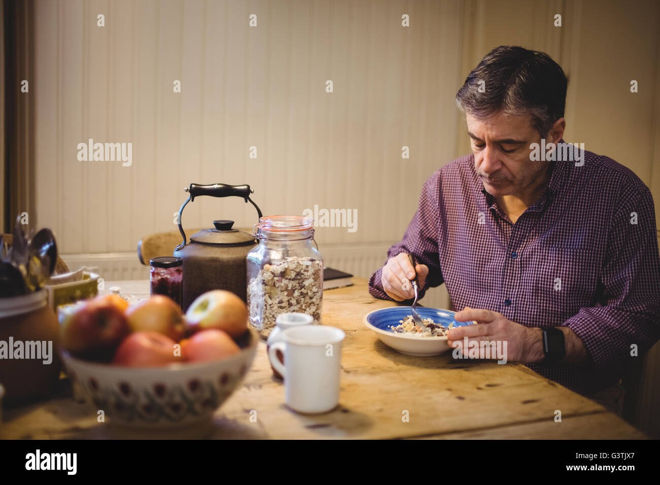 Mature man having breakfast Stock Photo - Alamy