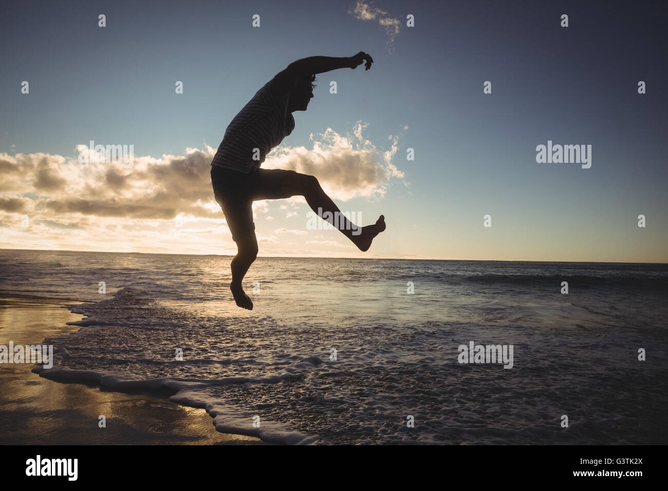Man jumping on the beach Stock Photo - Alamy