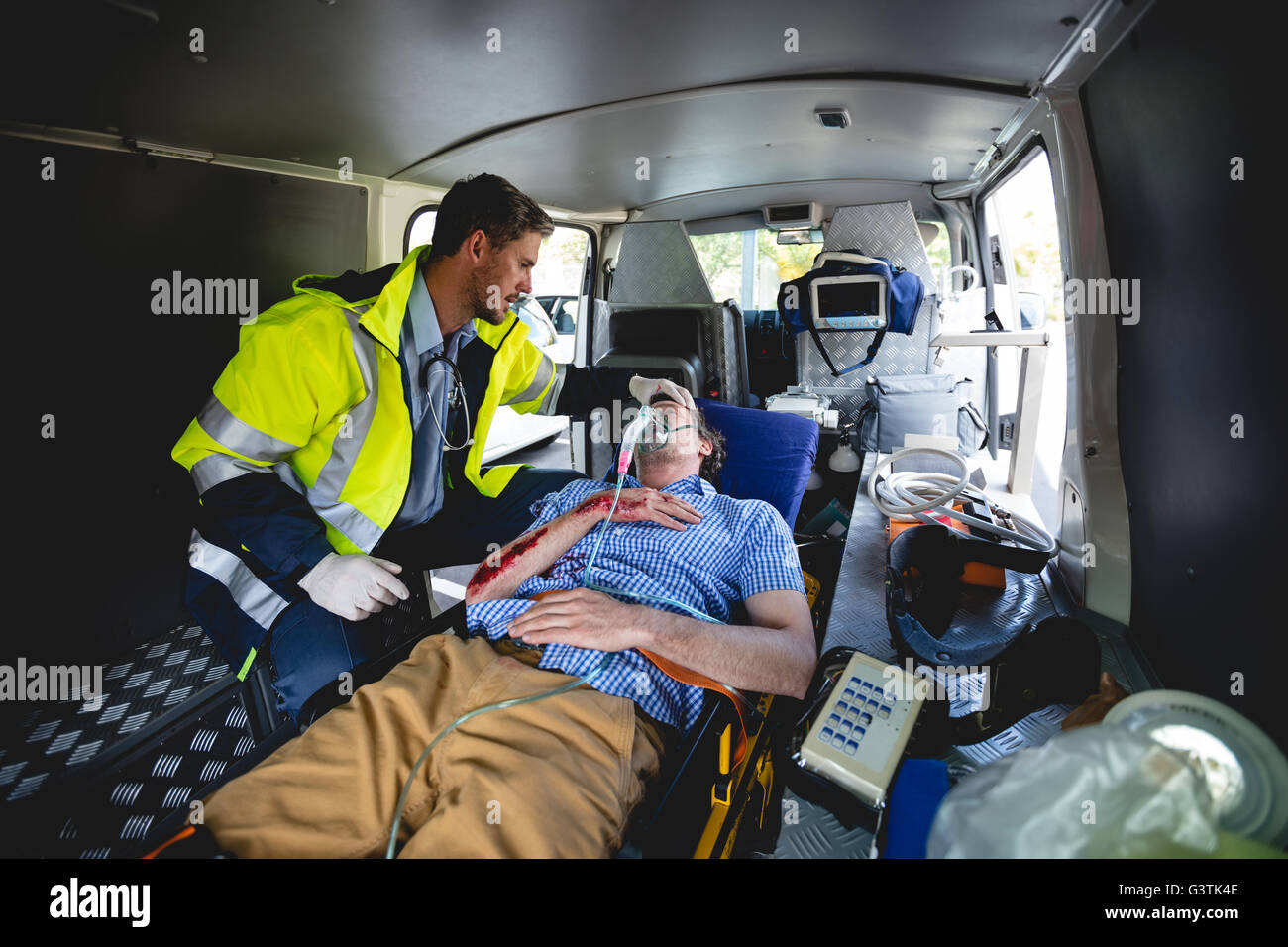 Injured man with ambulance man Stock Photo - Alamy