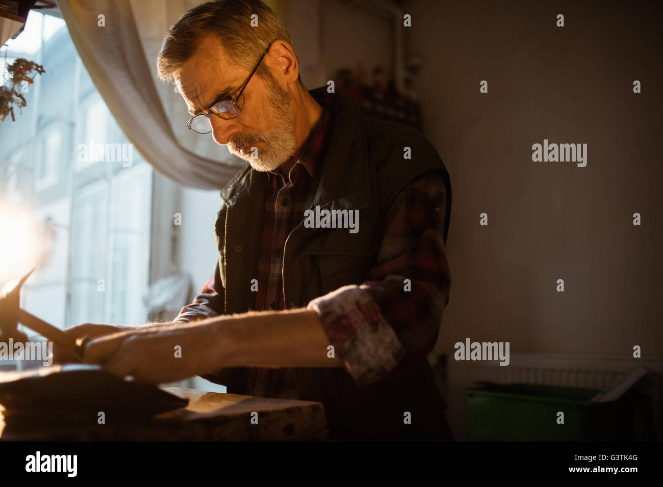 Low angle view of cobbler making a shoe with a hammer Stock Photo - Alamy
