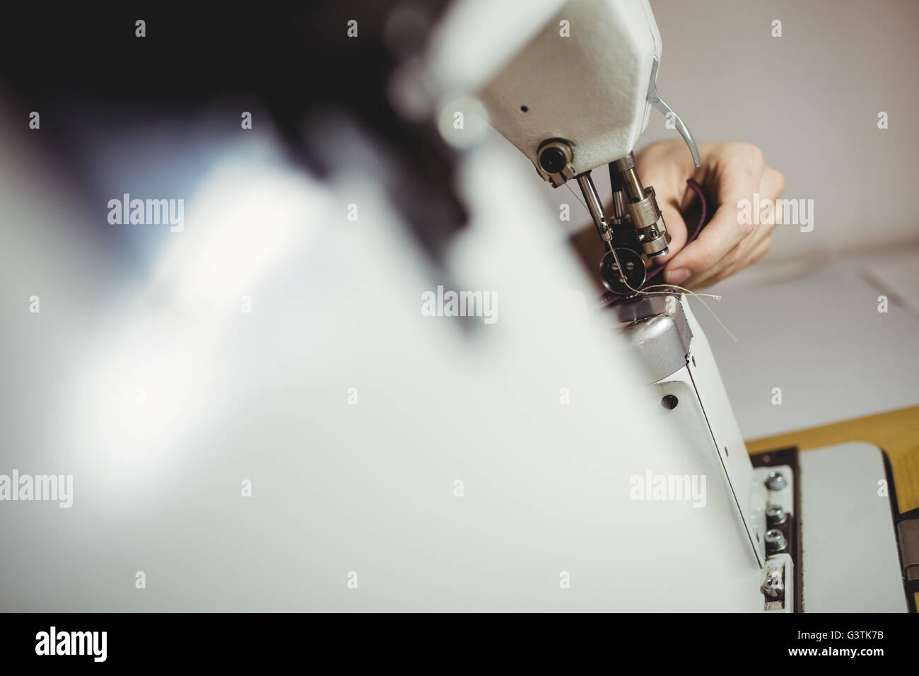 Close up of hand using a sewing machine Stock Photo - Alamy