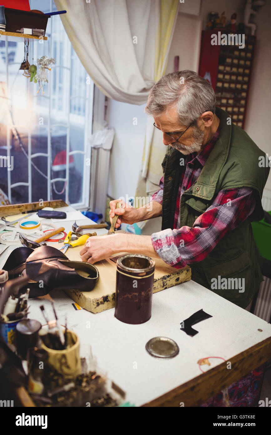 Portrait of cobbler putting wax on materials Stock Photo - Alamy