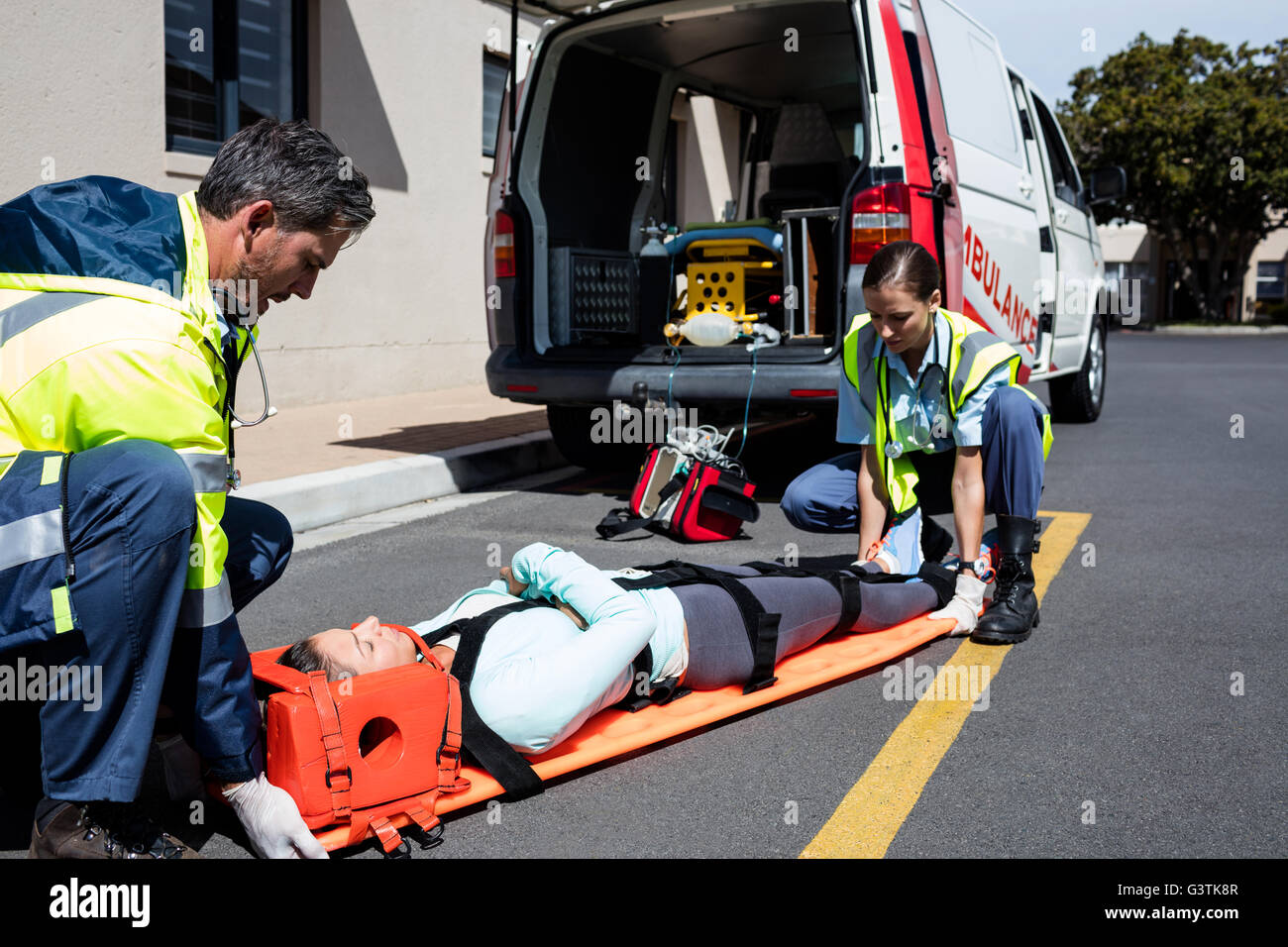 Ambulance men taking care of injured people Stock Photo - Alamy