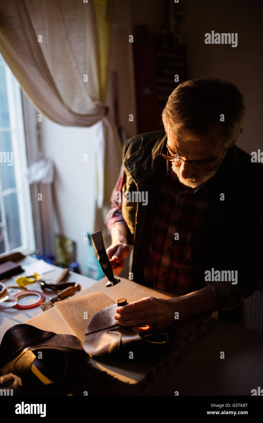 High angle view of cobbler making a shoe with a hammer Stock Photo - Alamy