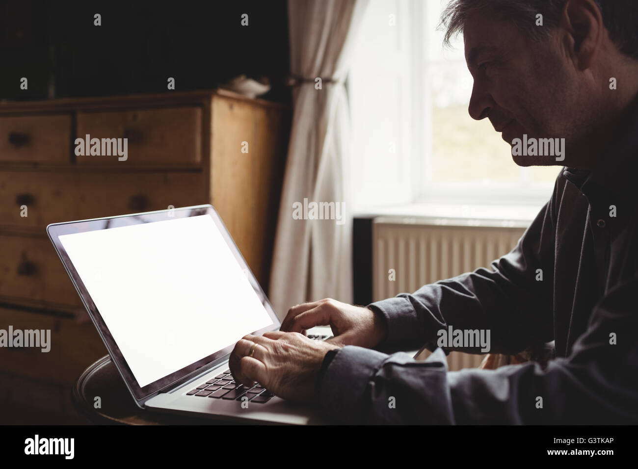 Mature male typing laptop in hi-res stock photography and images - Alamy