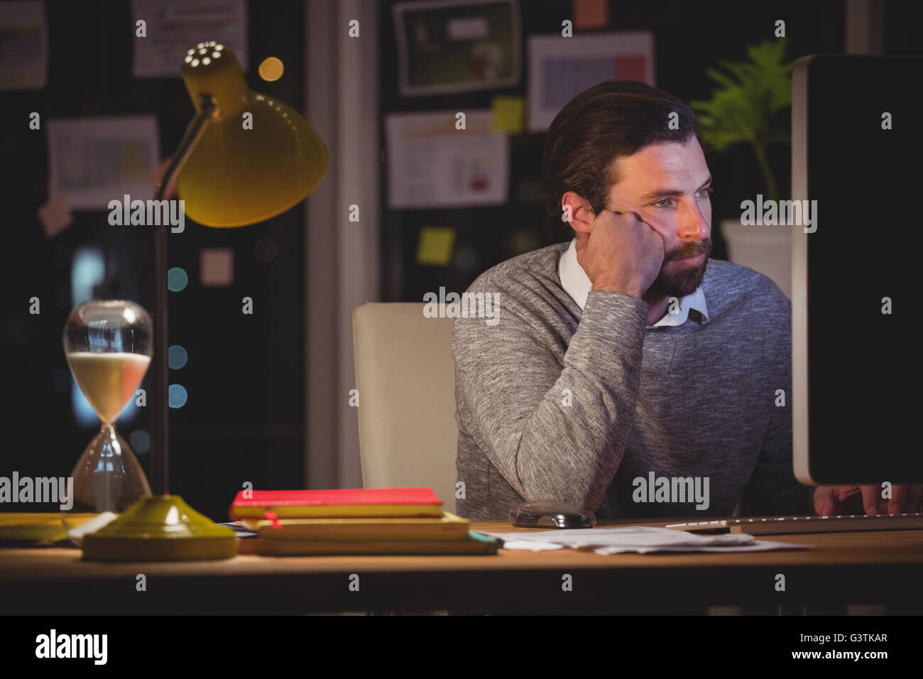 Exhausted hipster looking using computer Stock Photo - Alamy