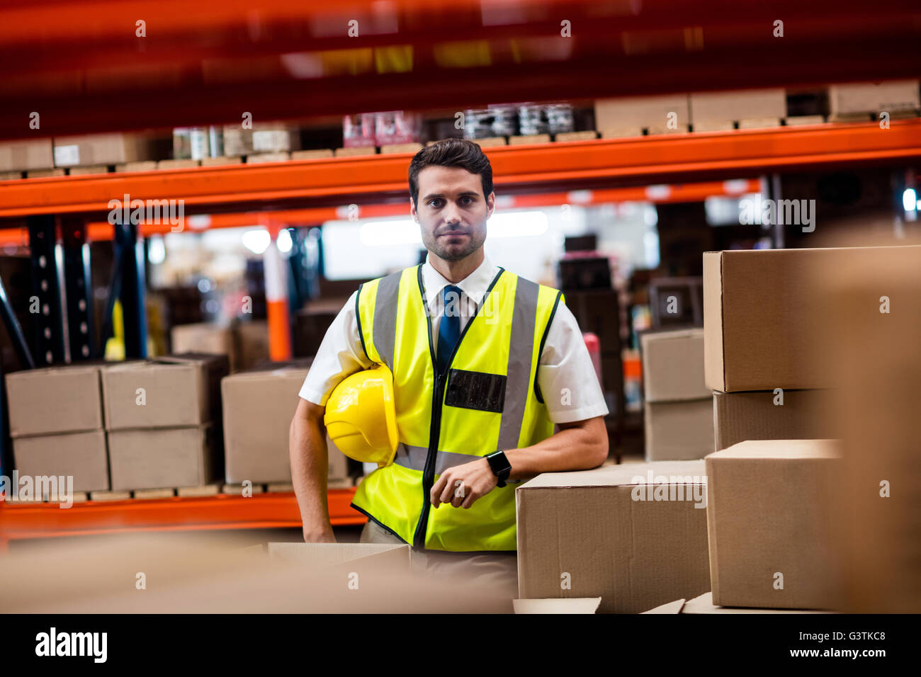 Warehouse manager standing with helmet Stock Photo - Alamy