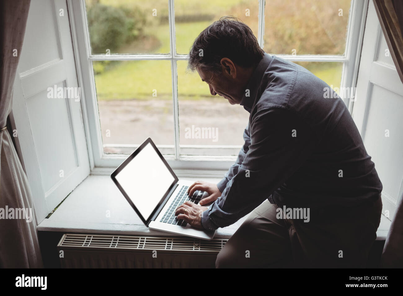 Mature male laptop typing hi-res stock photography and images - Alamy