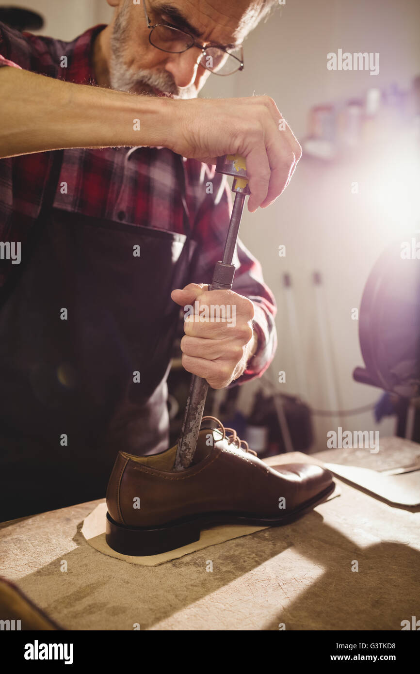 Portrait of cobbler making shoes Stock Photo - Alamy