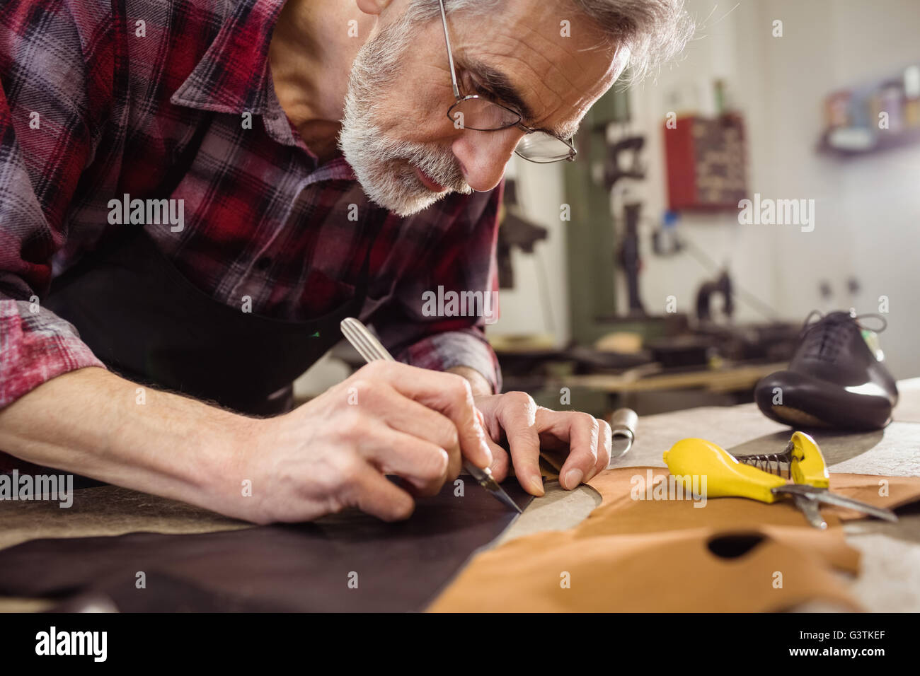 Close up of concentrated cobbler working Stock Photo - Alamy
