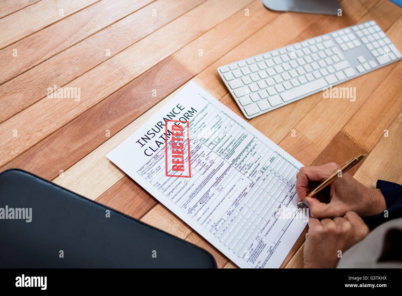 Hand writing on an insurance claim form Stock Photo - Alamy