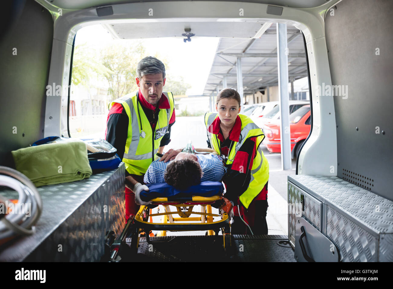 Injured man with ambulance men Stock Photo - Alamy