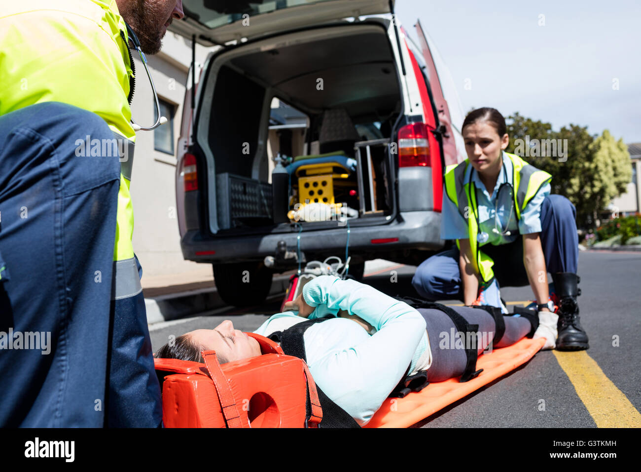 Ambulance men taking care of injured people Stock Photo - Alamy