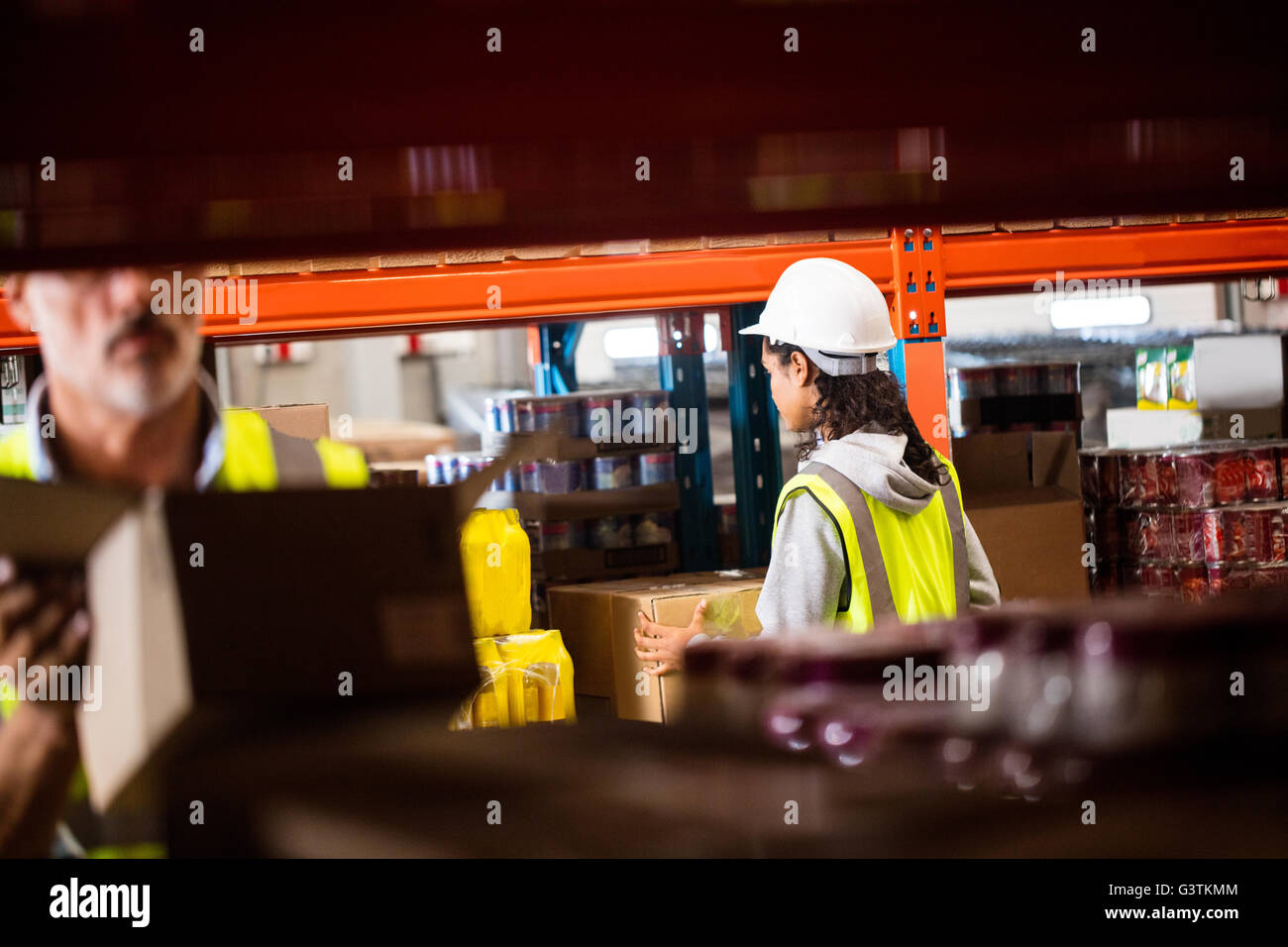 Workers warehouse tidying the shelves Stock Photo - Alamy