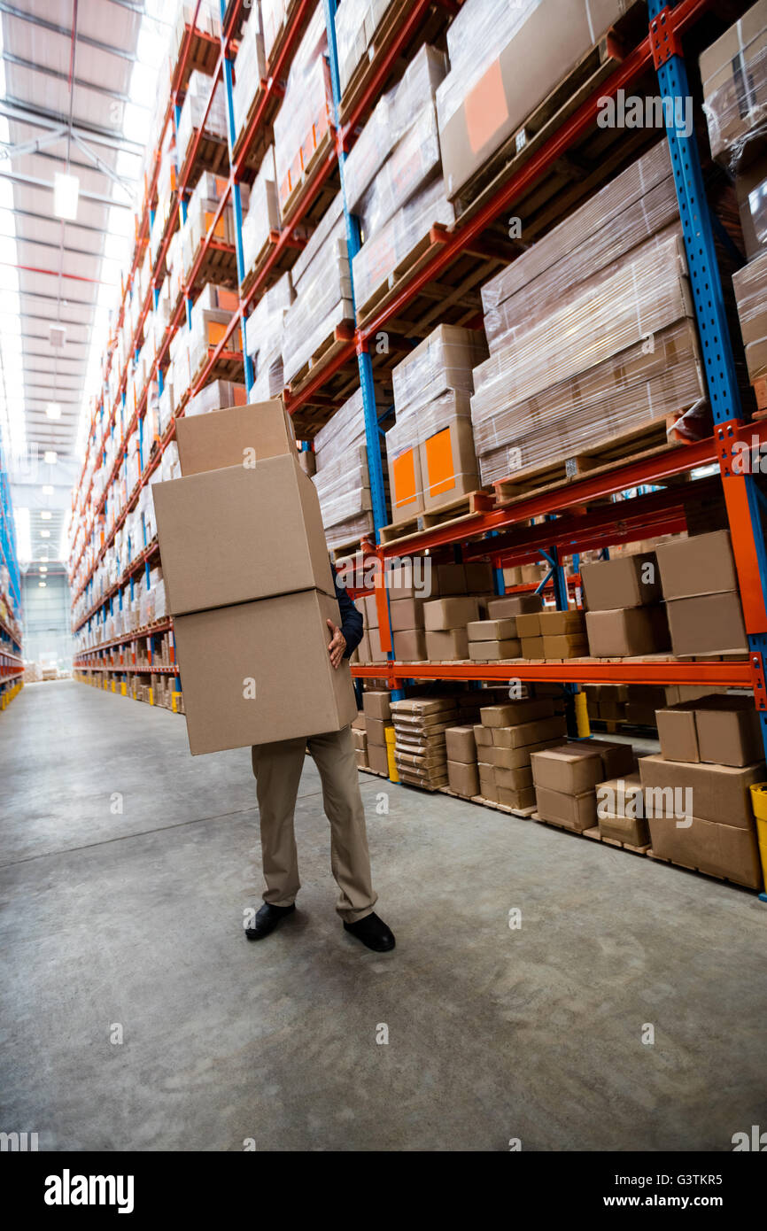 Worker carrying boxes Stock Photo - Alamy