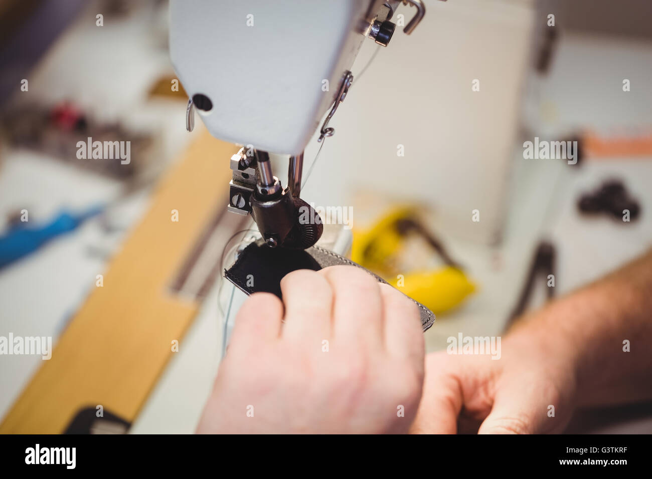 High angle view of hands using a sewing machine Stock Photo - Alamy