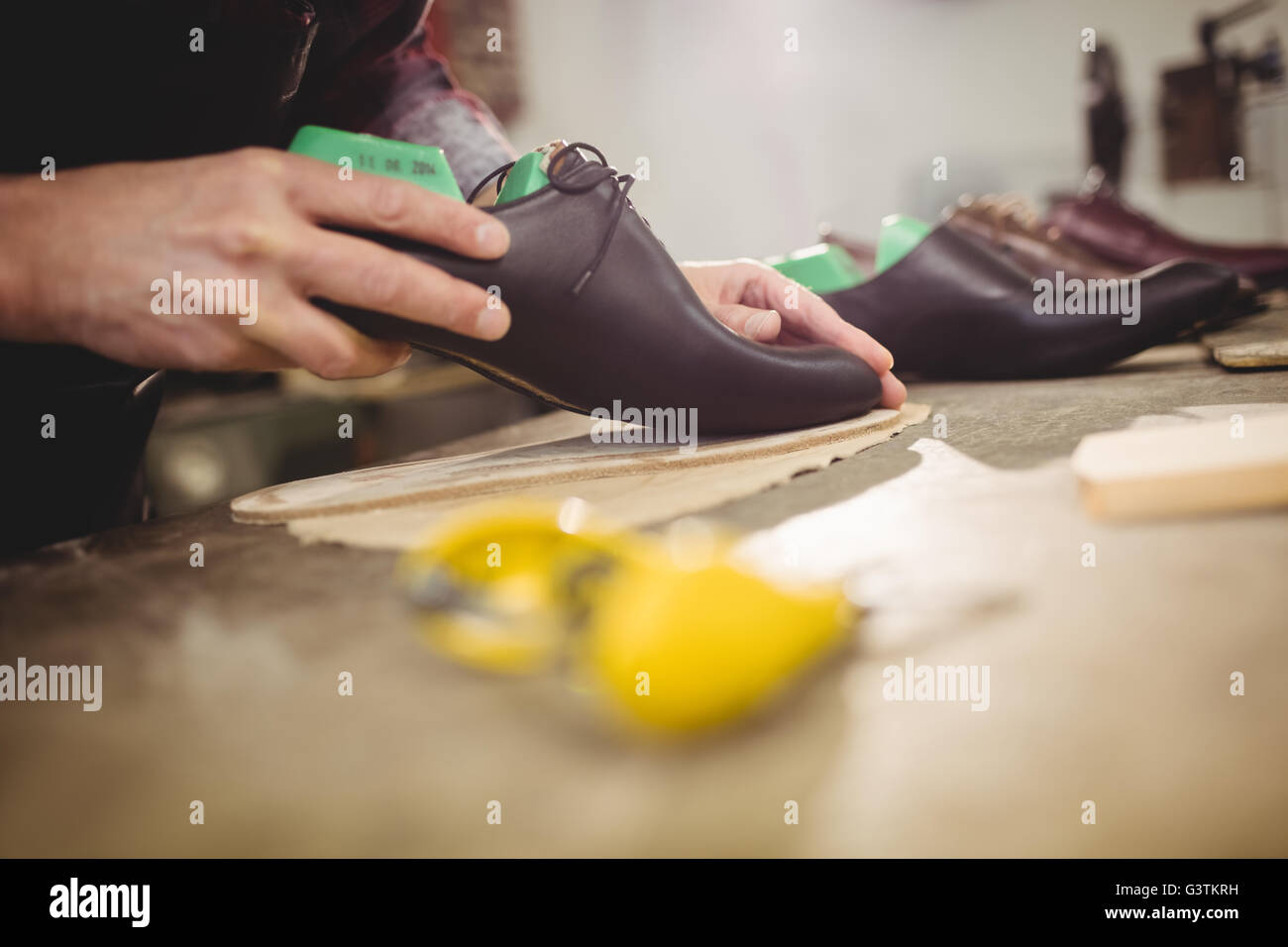 Man holding up shoe hi-res stock photography and images - Alamy