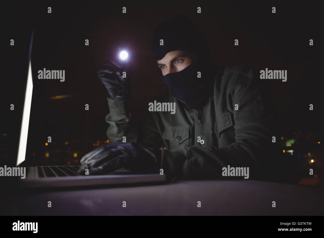 Hacker using a laptop Stock Photo - Alamy