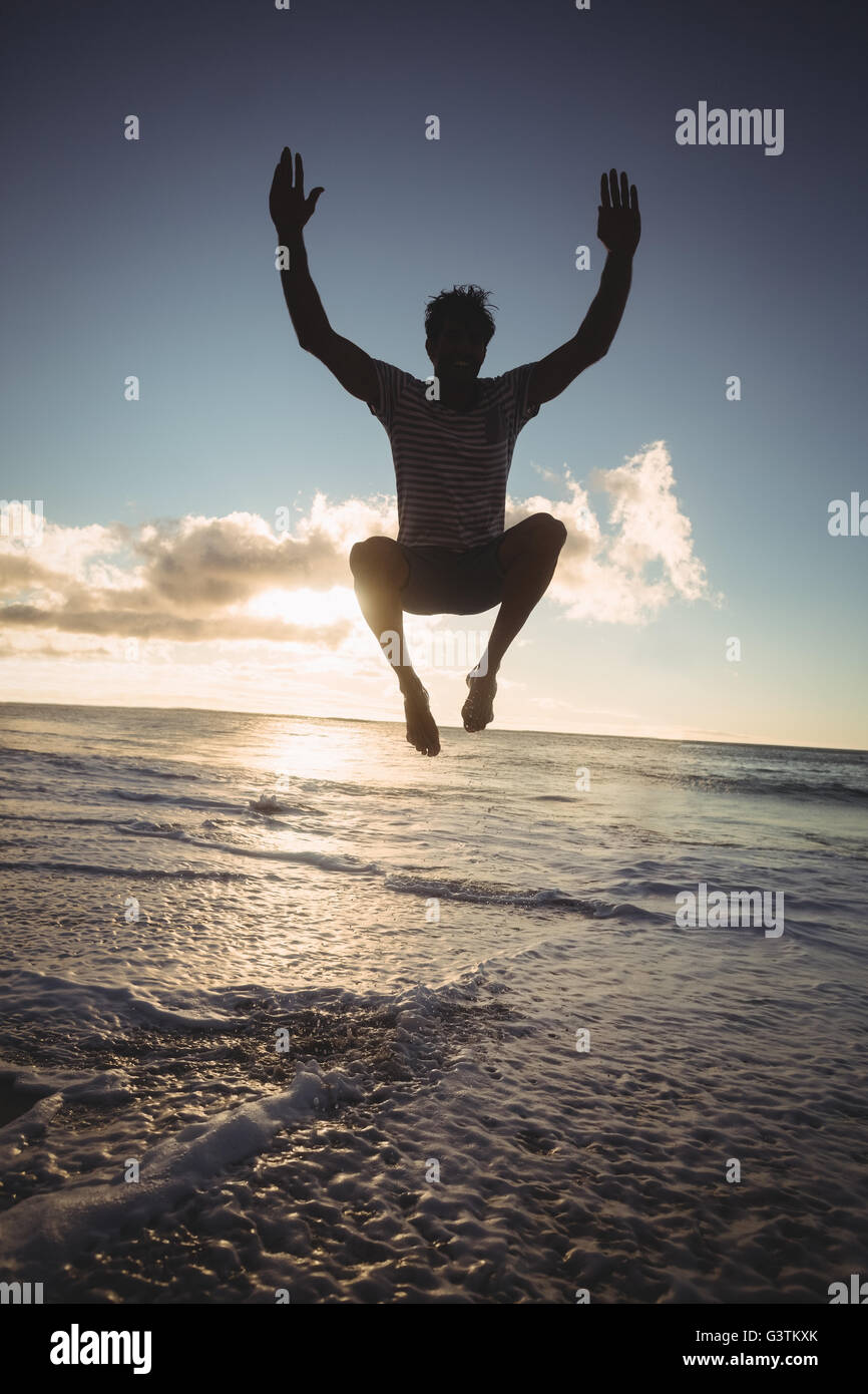 Man jumping on the beach hi-res stock photography and images - Alamy