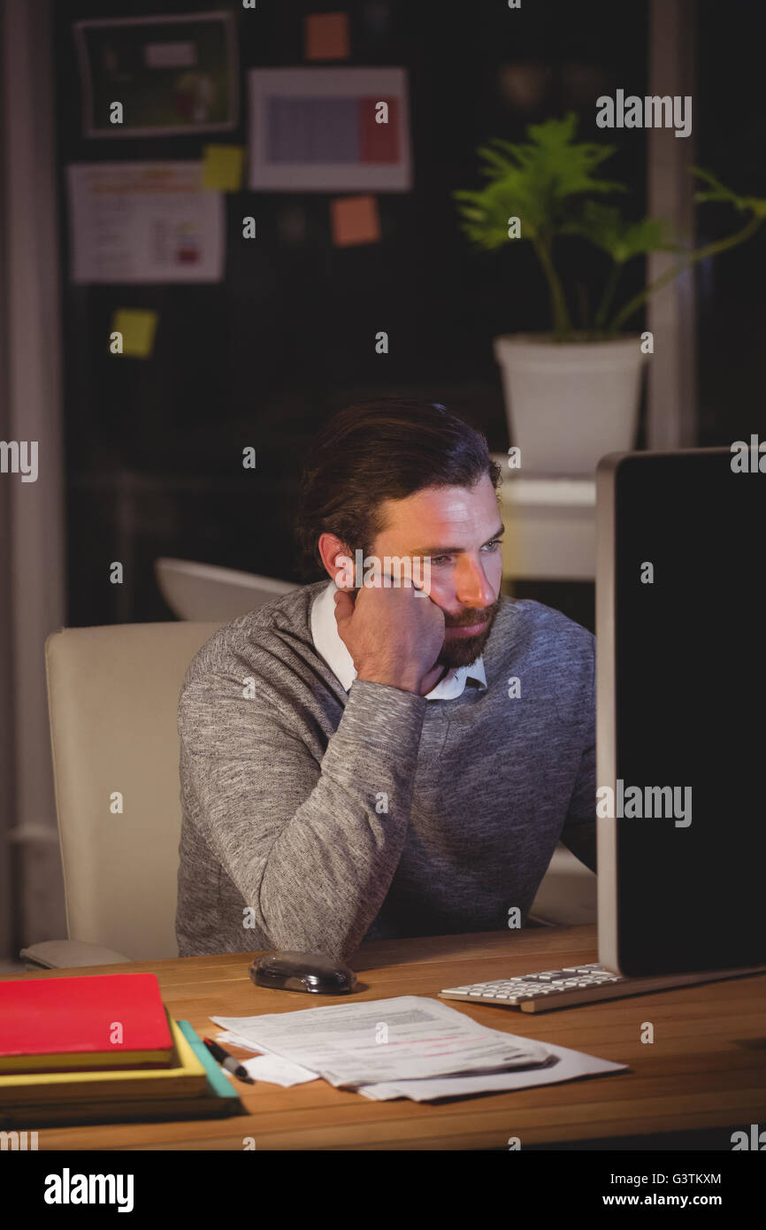 Exhausted hipster looking using computer Stock Photo - Alamy