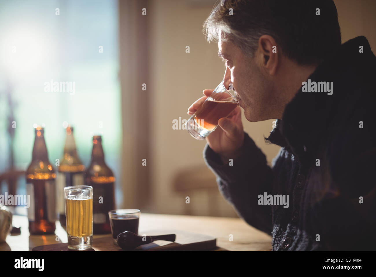 Mature man drinking alcohol Stock Photo - Alamy