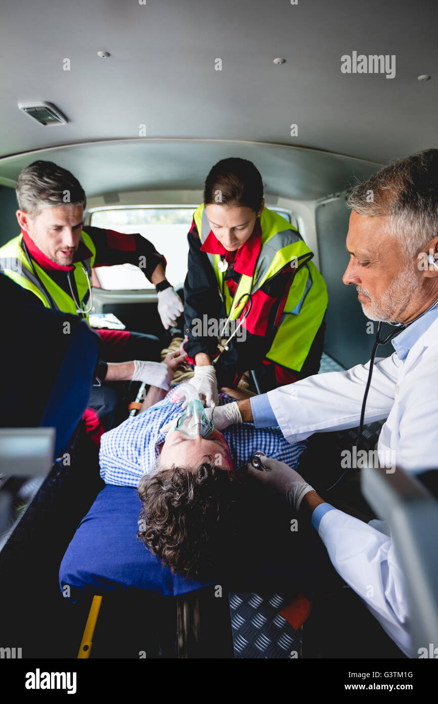 Injured man with ambulance men Stock Photo - Alamy