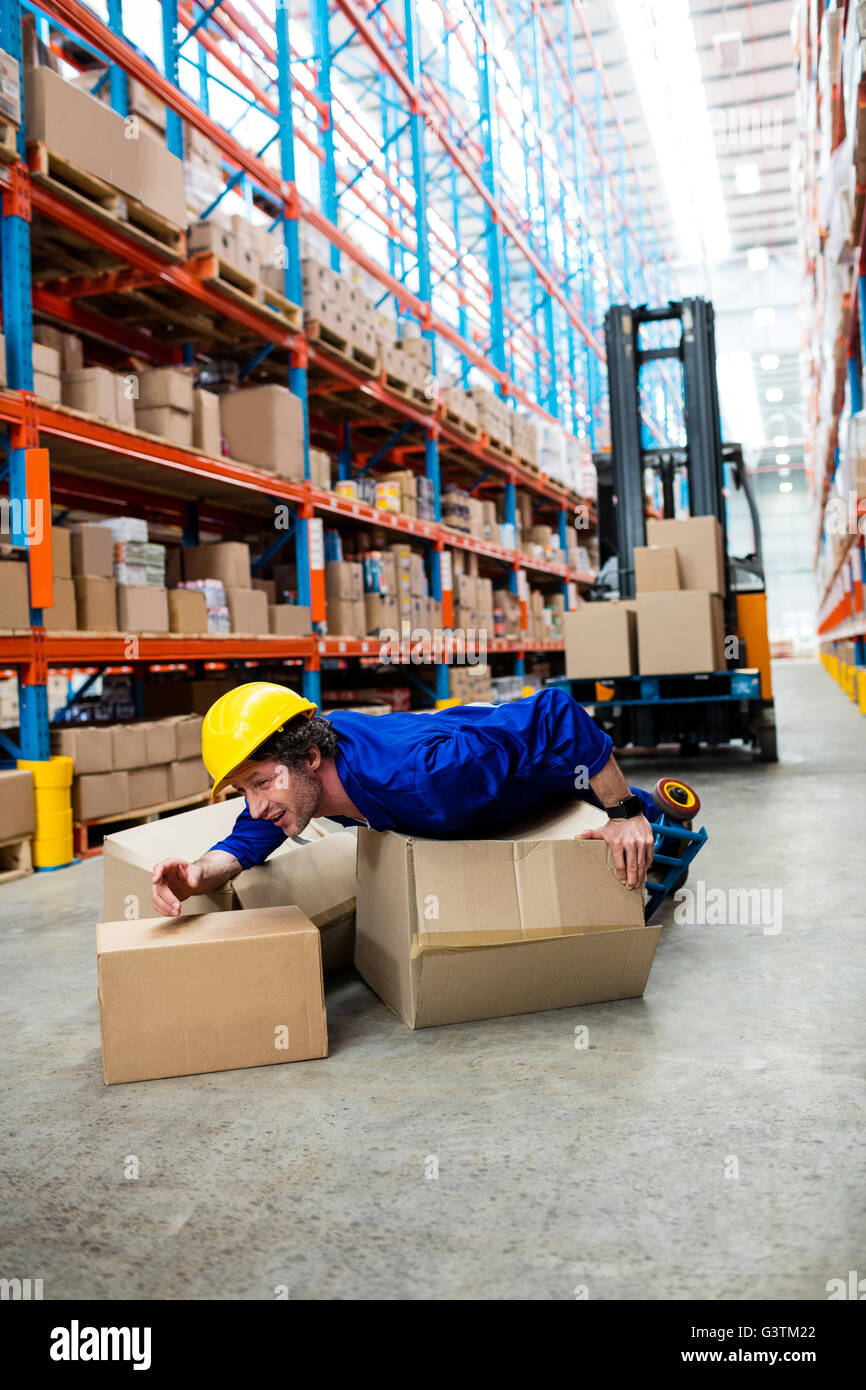 Worker lying on boxes Stock Photo - Alamy
