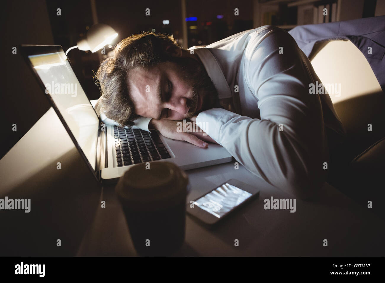 Businessman sleeping on his laptop at night Stock Photo - Alamy