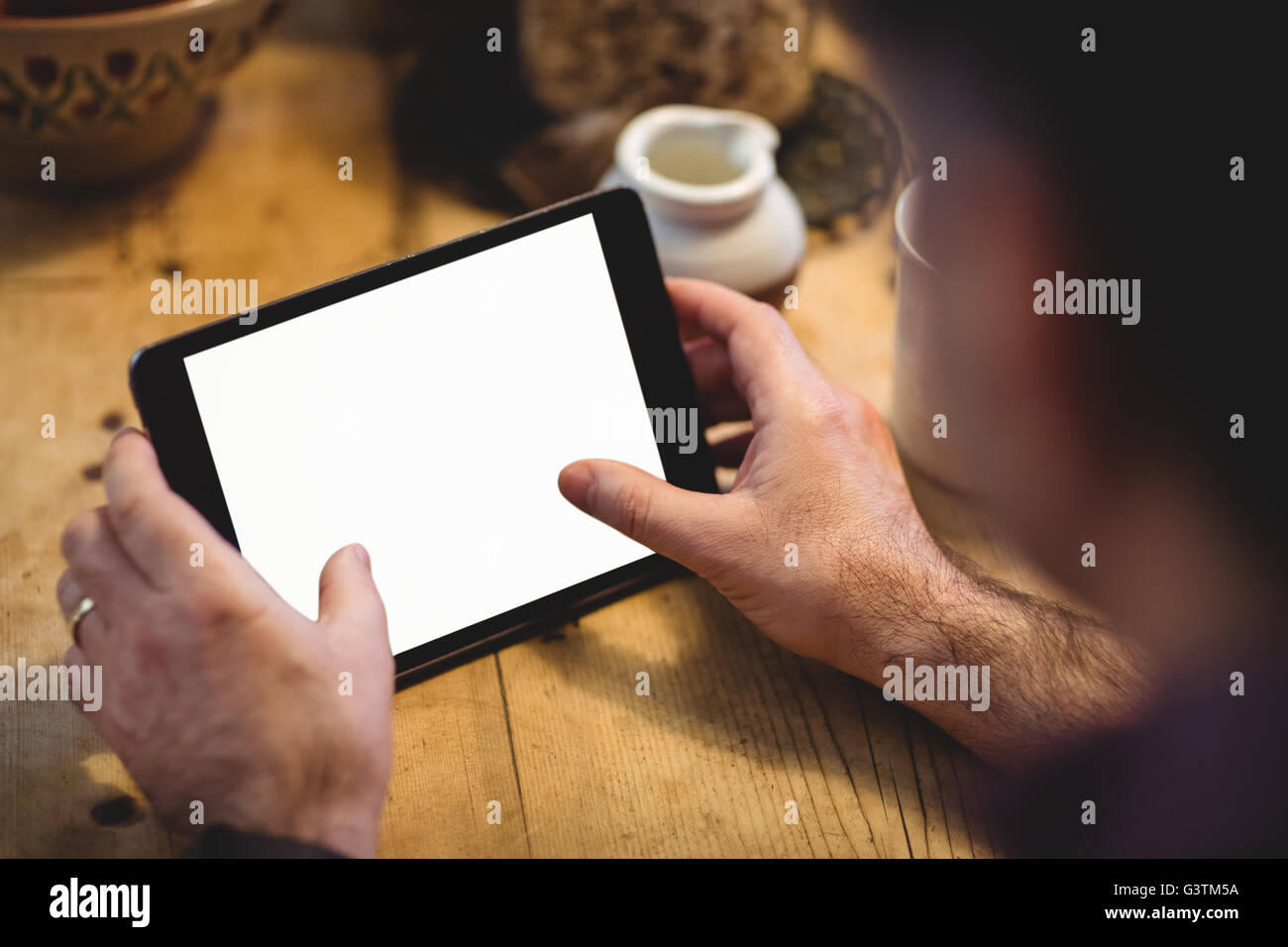 Cropped image of casual man using tablet Stock Photo - Alamy