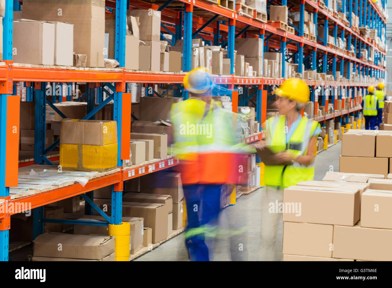 Warehouse workers working together Stock Photo - Alamy