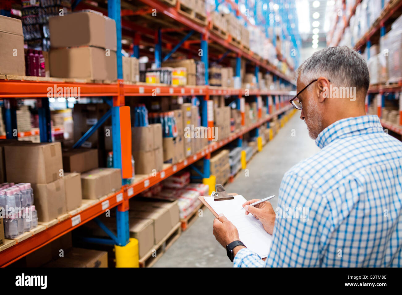 Manager writing on his clipboard Stock Photo - Alamy