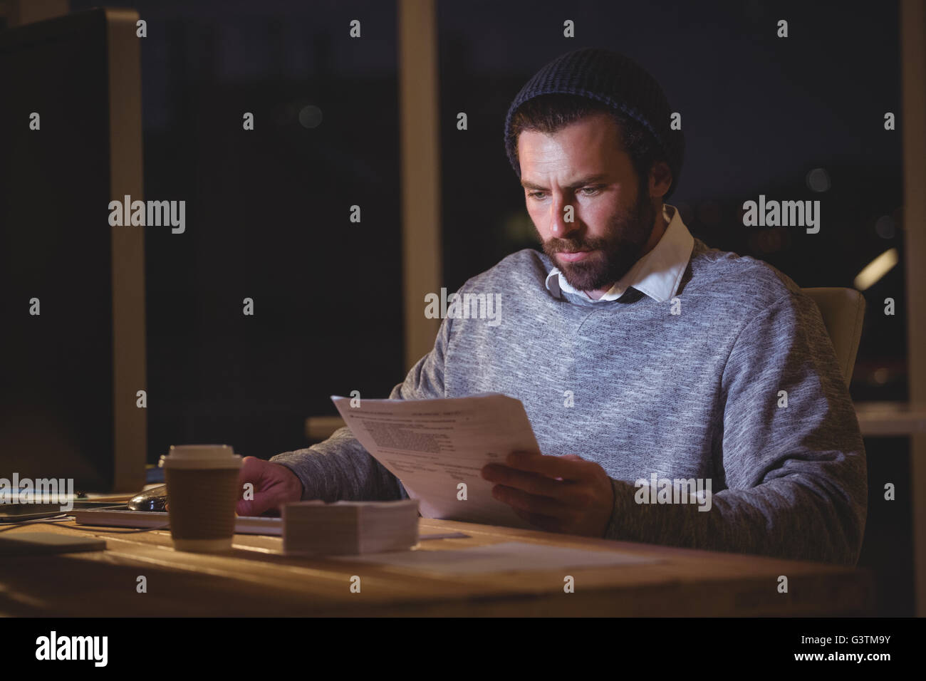 Hipster reading documents Stock Photo - Alamy