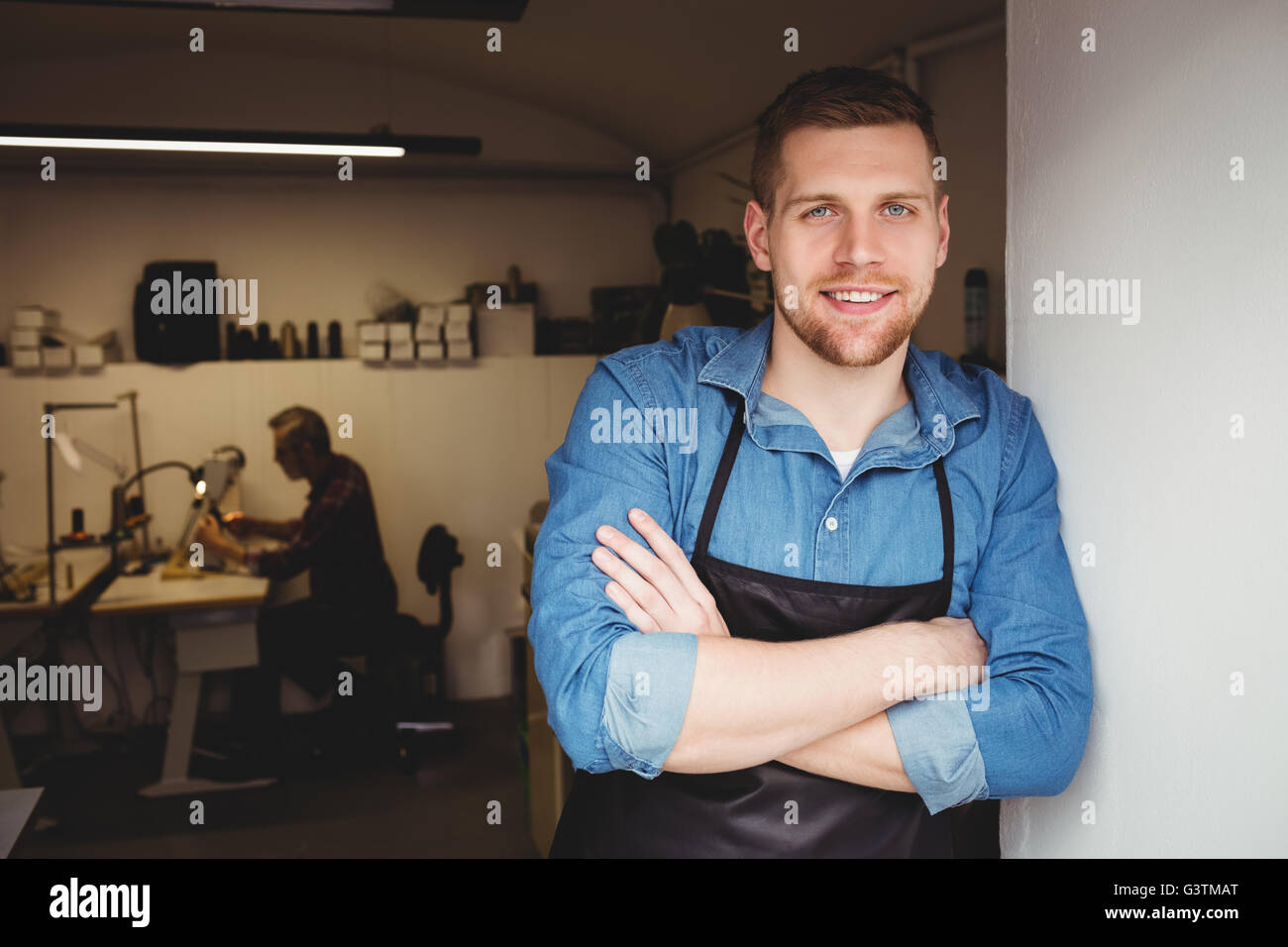 Young cobbler smiling and posing Stock Photo - Alamy