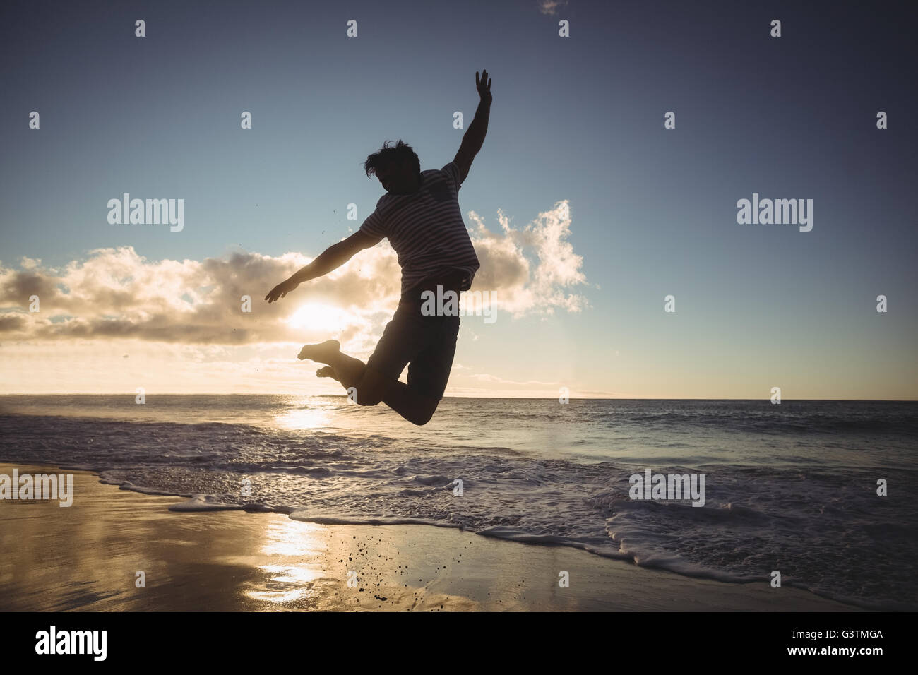 Man jumping on the beach Stock Photo - Alamy