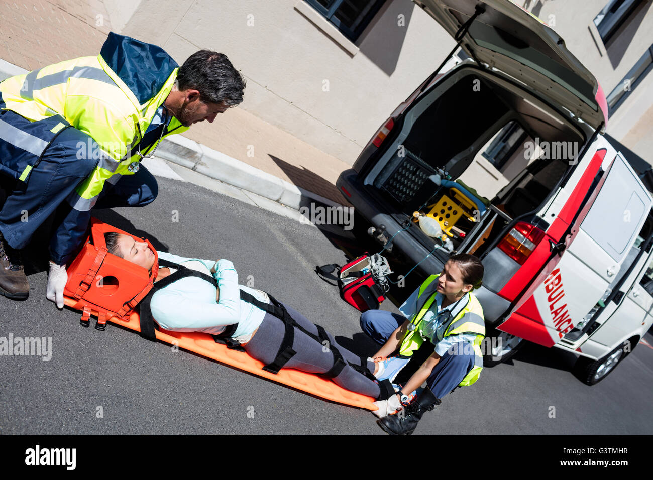 Ambulance men taking care of injured people Stock Photo - Alamy