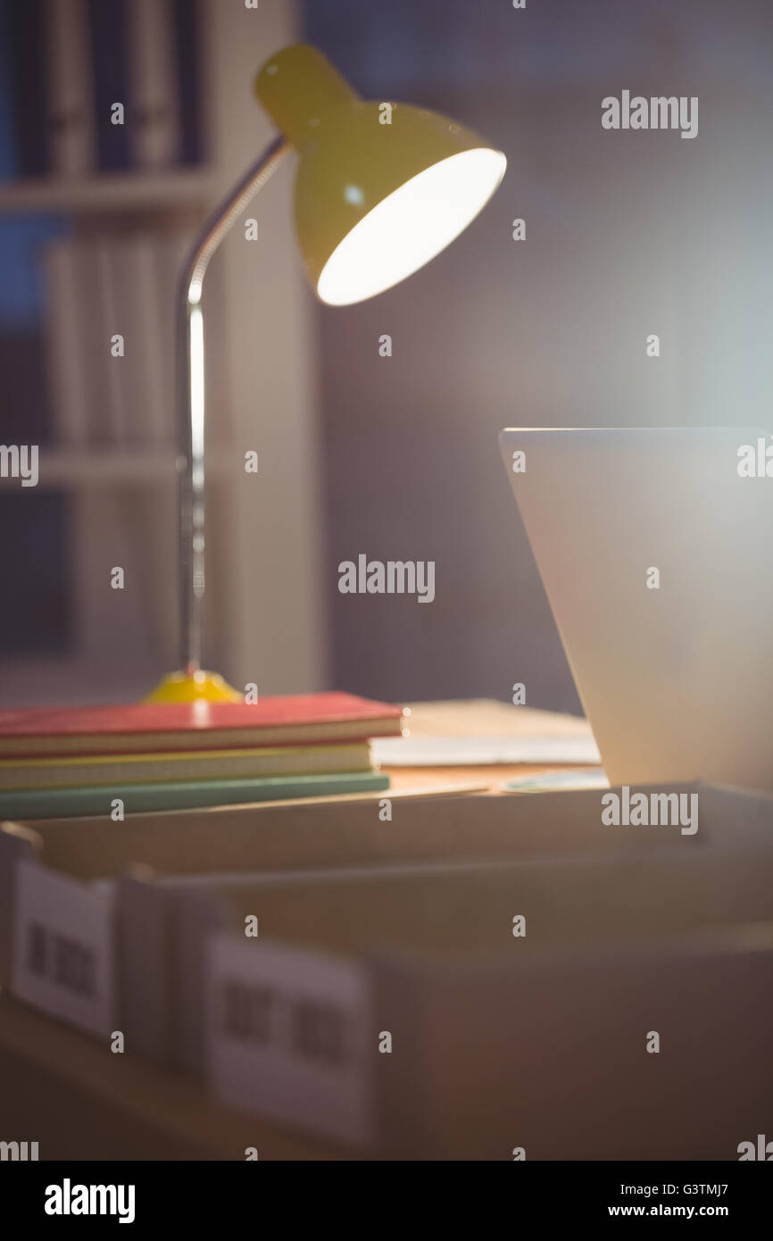 Lamp lighting a desk in the night Stock Photo - Alamy