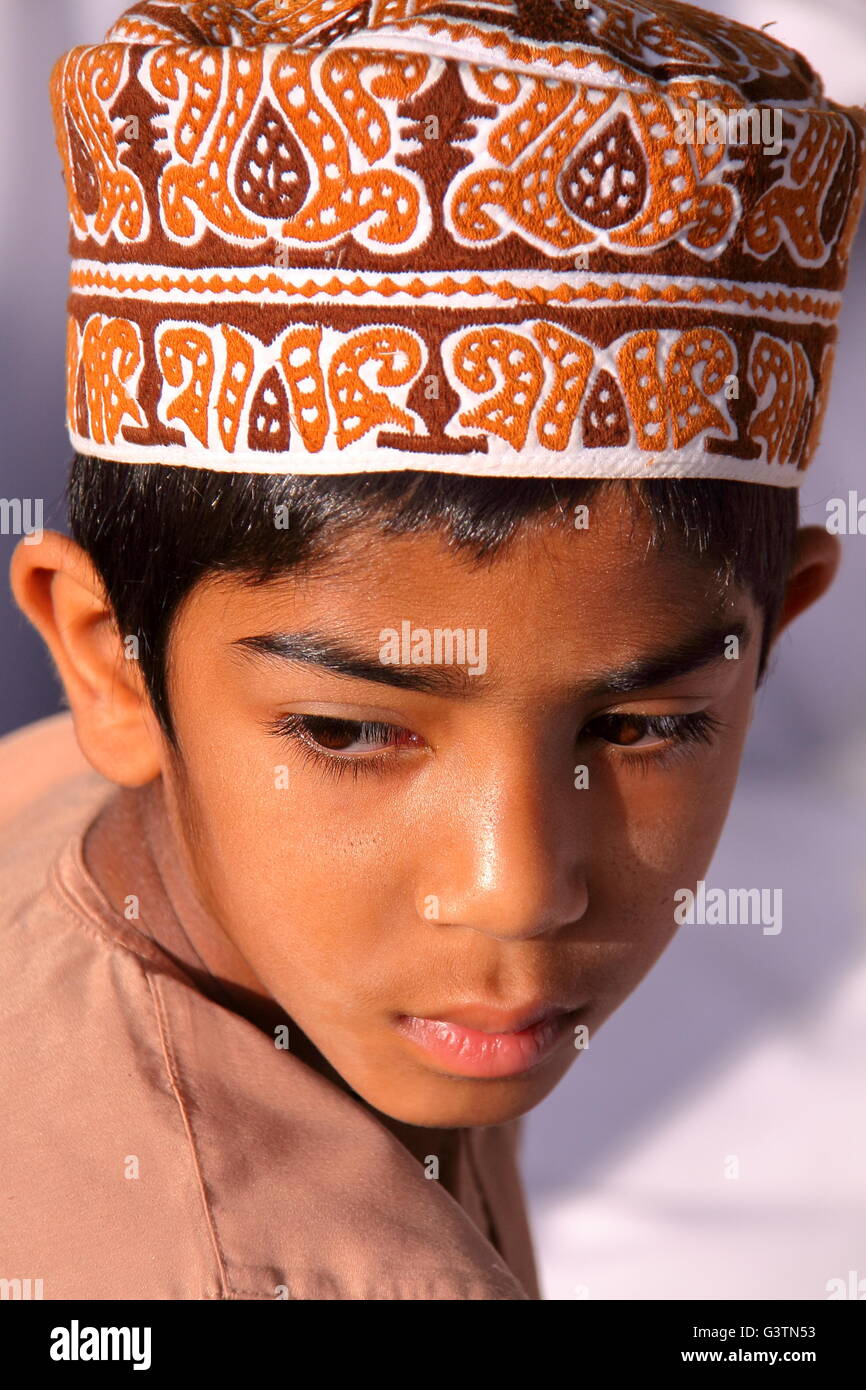 Portrait of a little Omani boy traditionally dressed attending the Goat ...