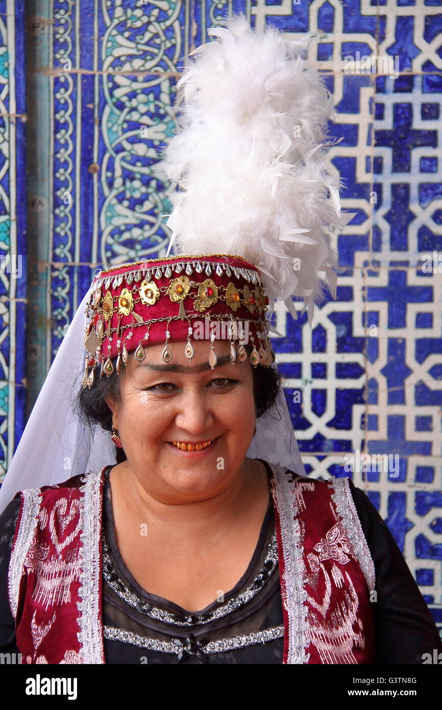 Traditionally dressed Uzbek woman posing at Tosh Hovli palace in Khiva ...