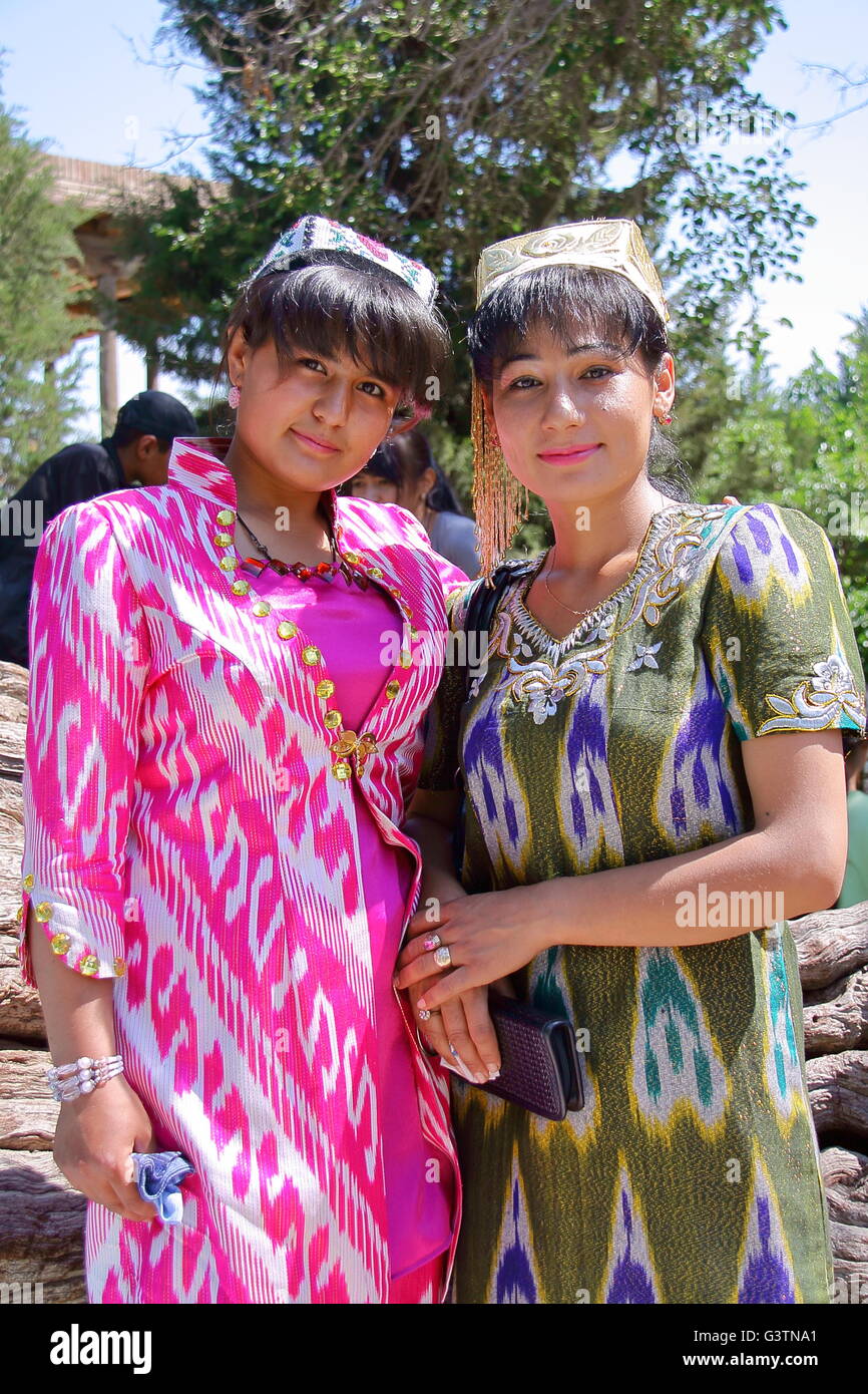 Two young Uzbek women traditionally dressed posing inside the ...