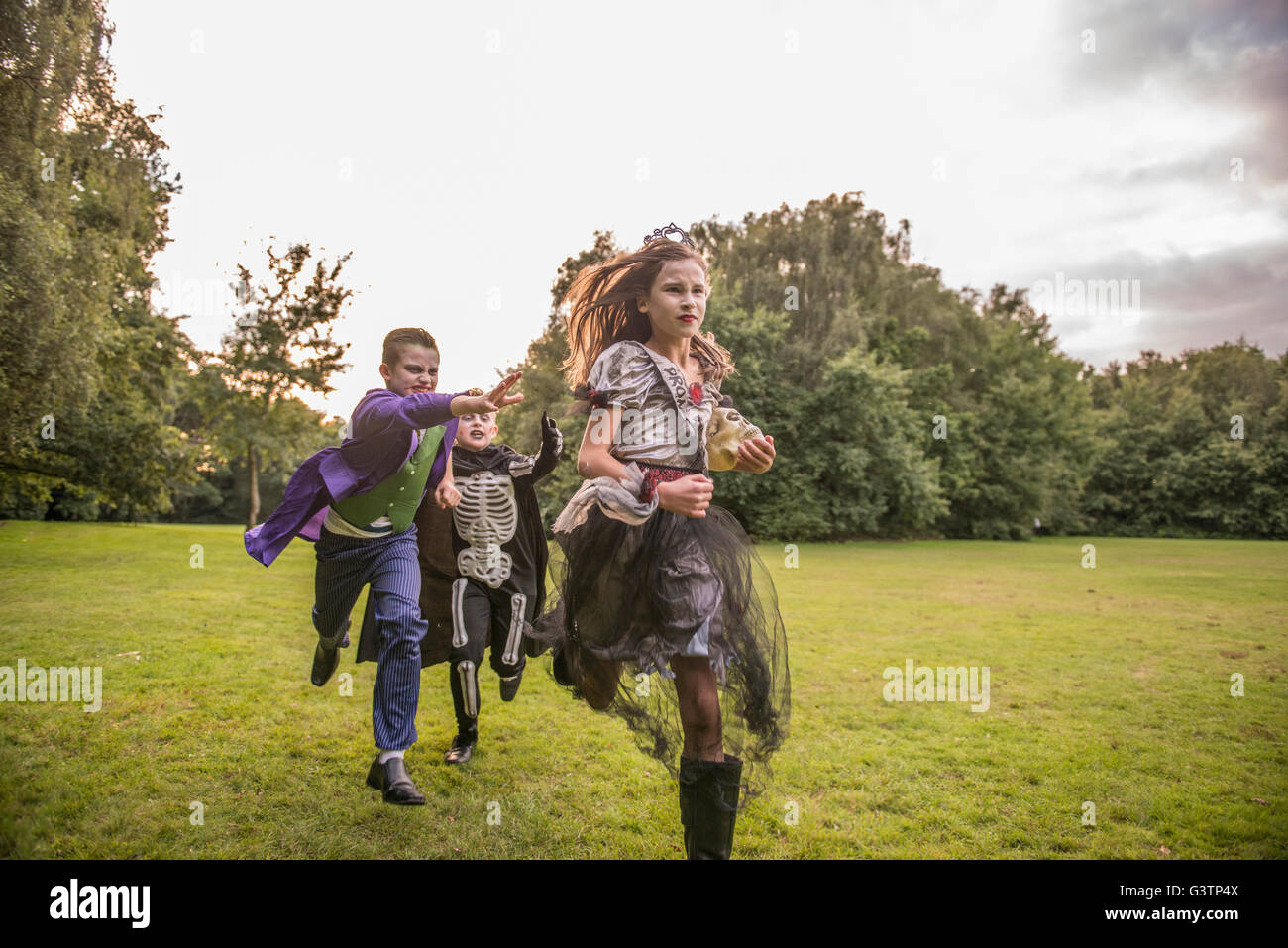 Children chase a girl dressed as a zombie prom queen for Halloween ...