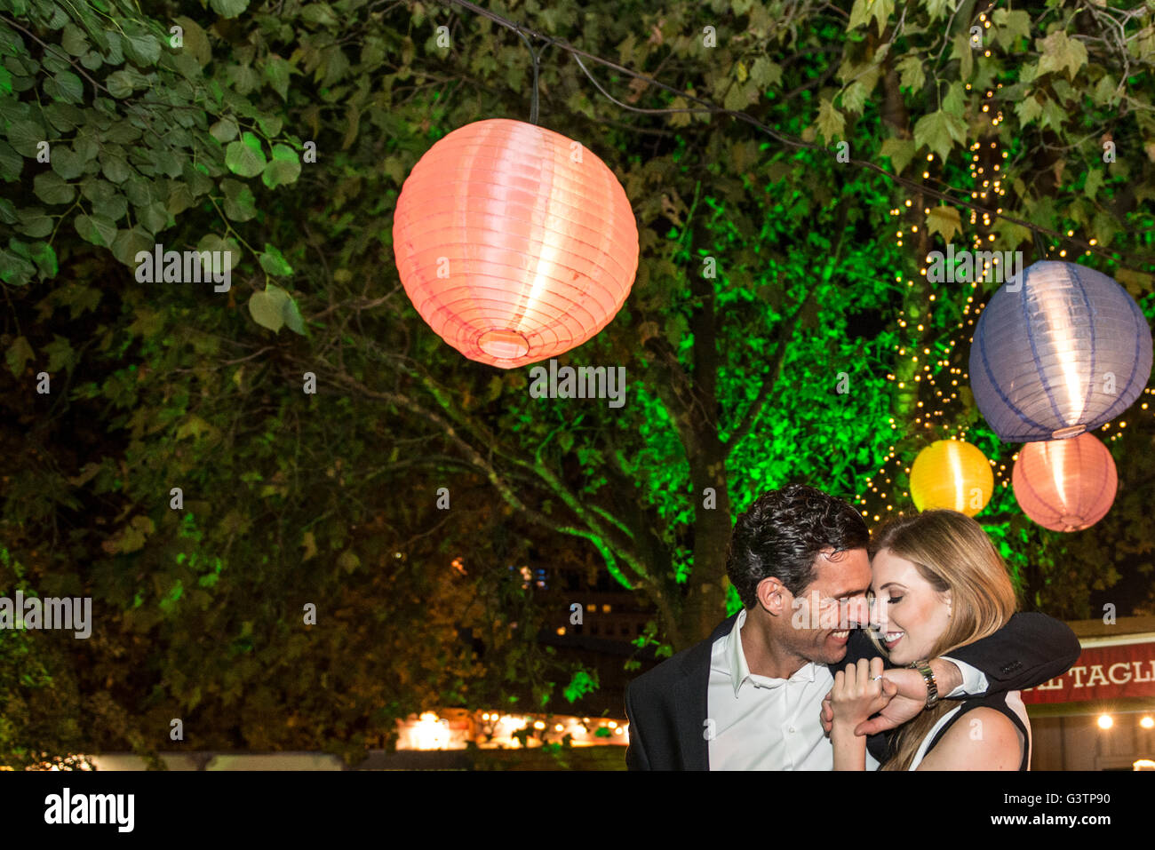 A smartly dressed couple leaving a bar on the South Bank in London ...