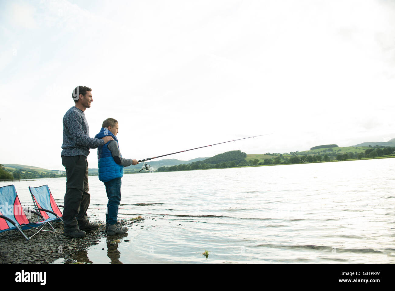 A father and son fishing from the shore of Bala Lake in Wales Stock ...