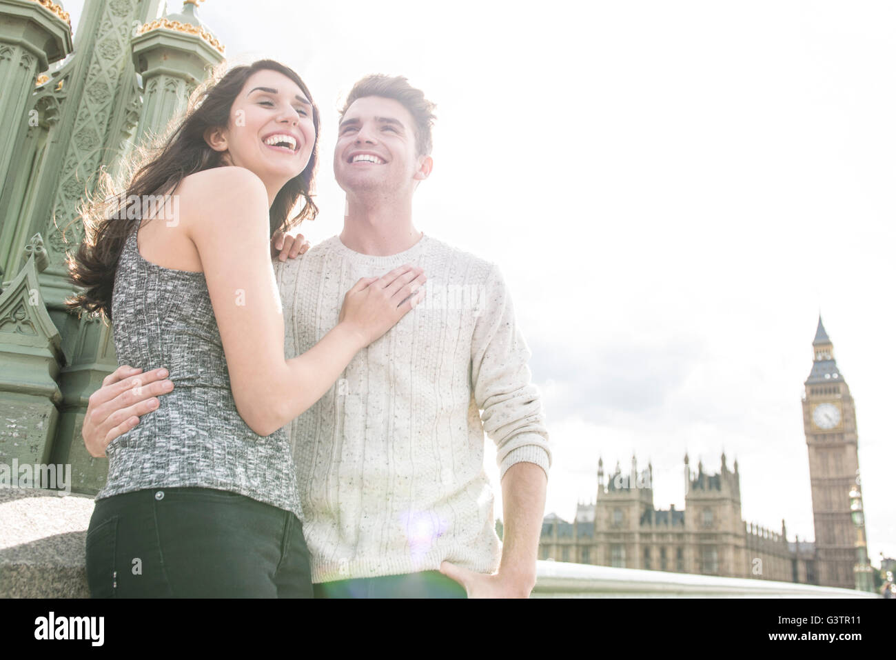 A young couple cuddling on Westminster Bridge in London Stock Photo - Alamy