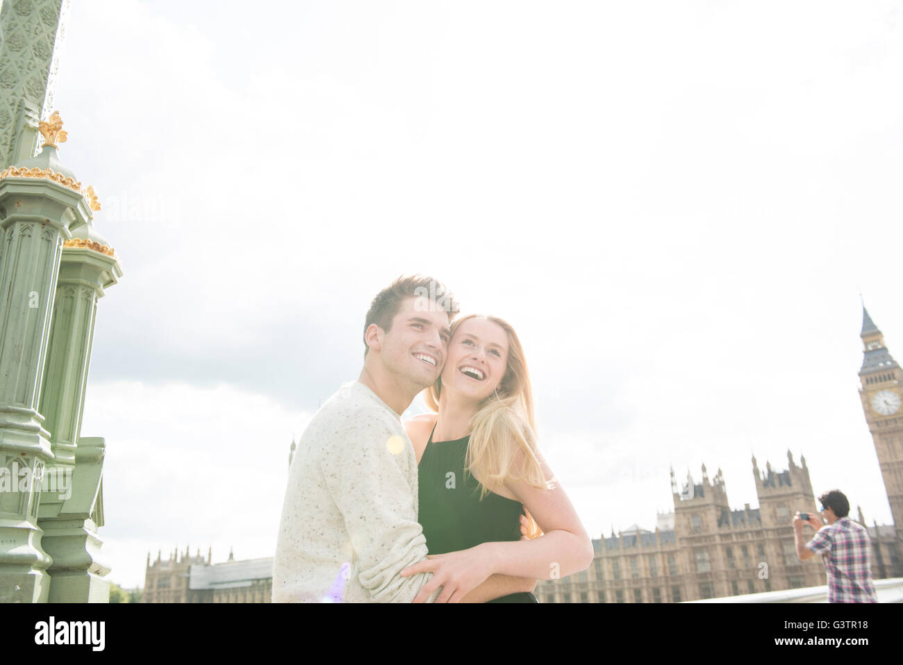 A young couple cuddling on Westminster Bridge in London Stock Photo - Alamy