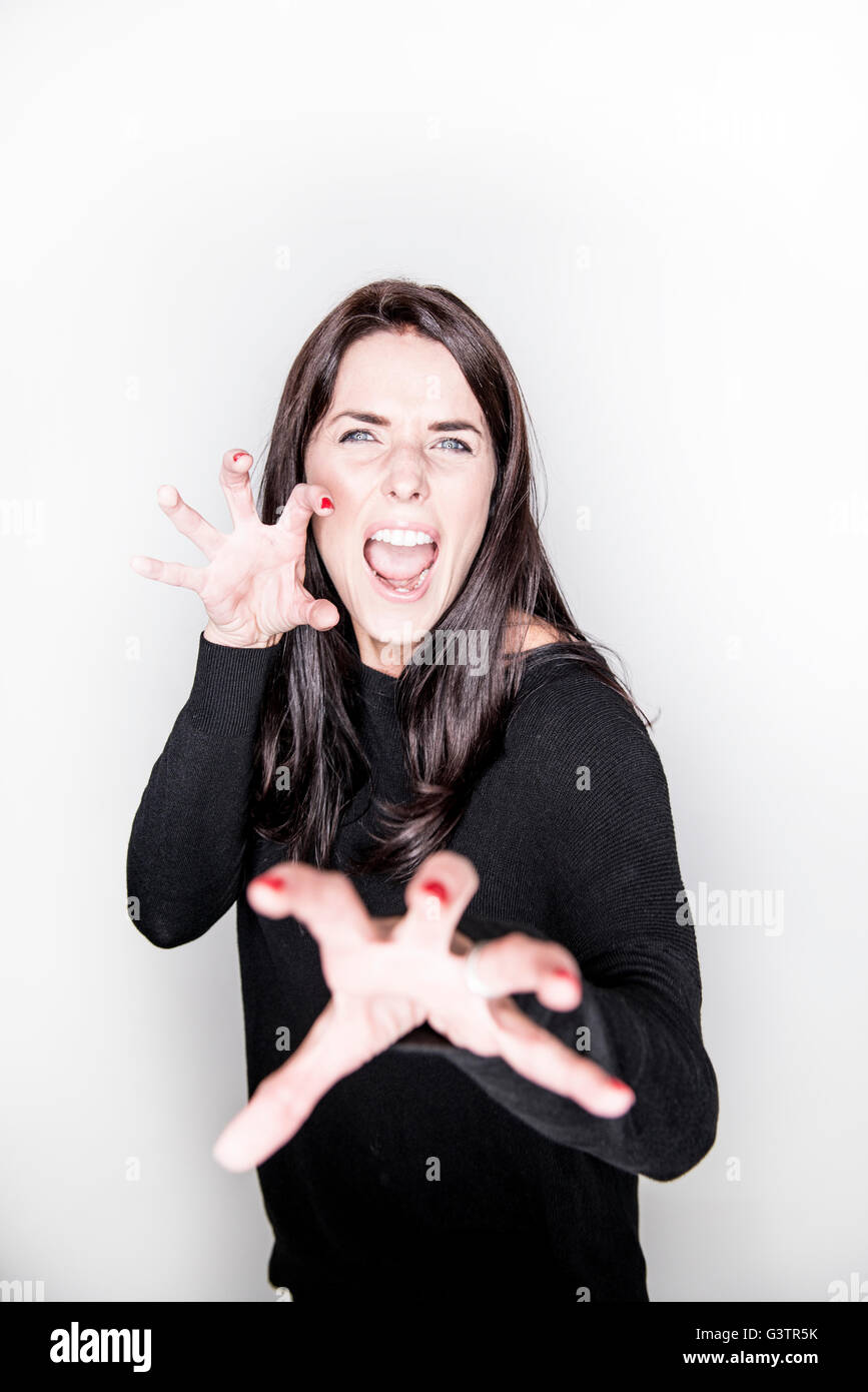 A young woman posing in a studio looking vampish Stock Photo - Alamy