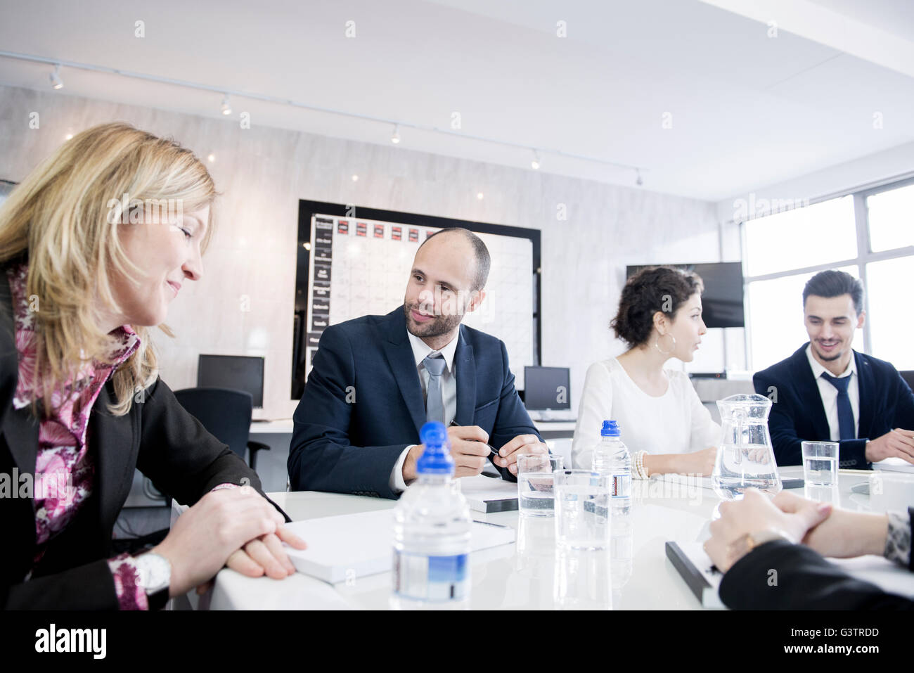 Professional people sitting in an office environment having a ...