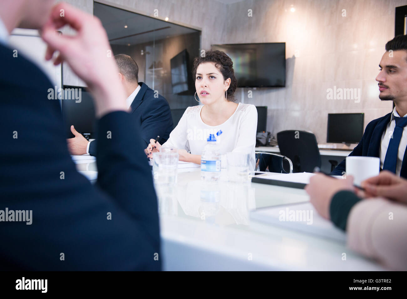 Professional people sitting in an office environment having a ...