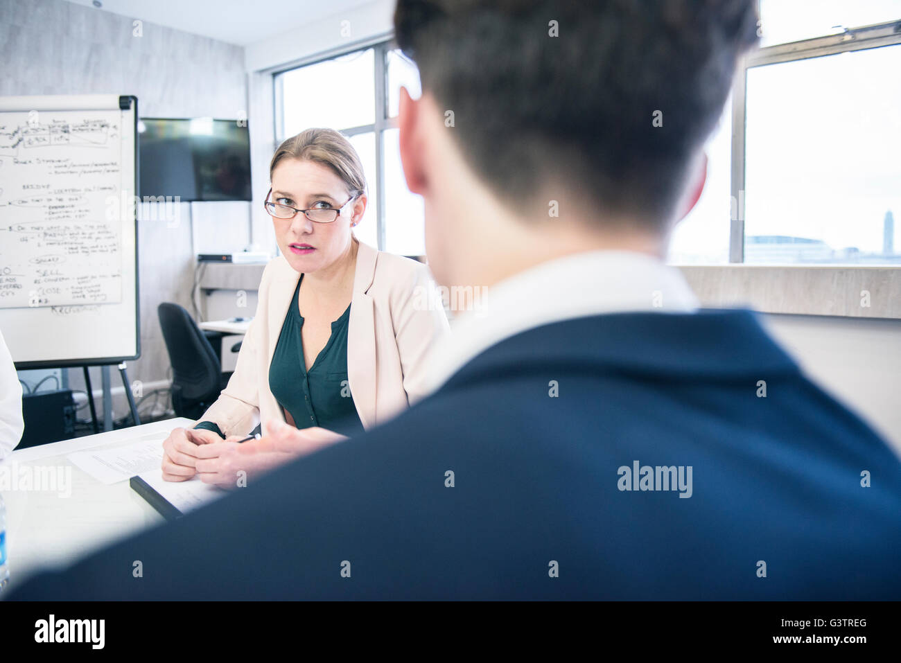 Professional people sitting in an office environment having a ...